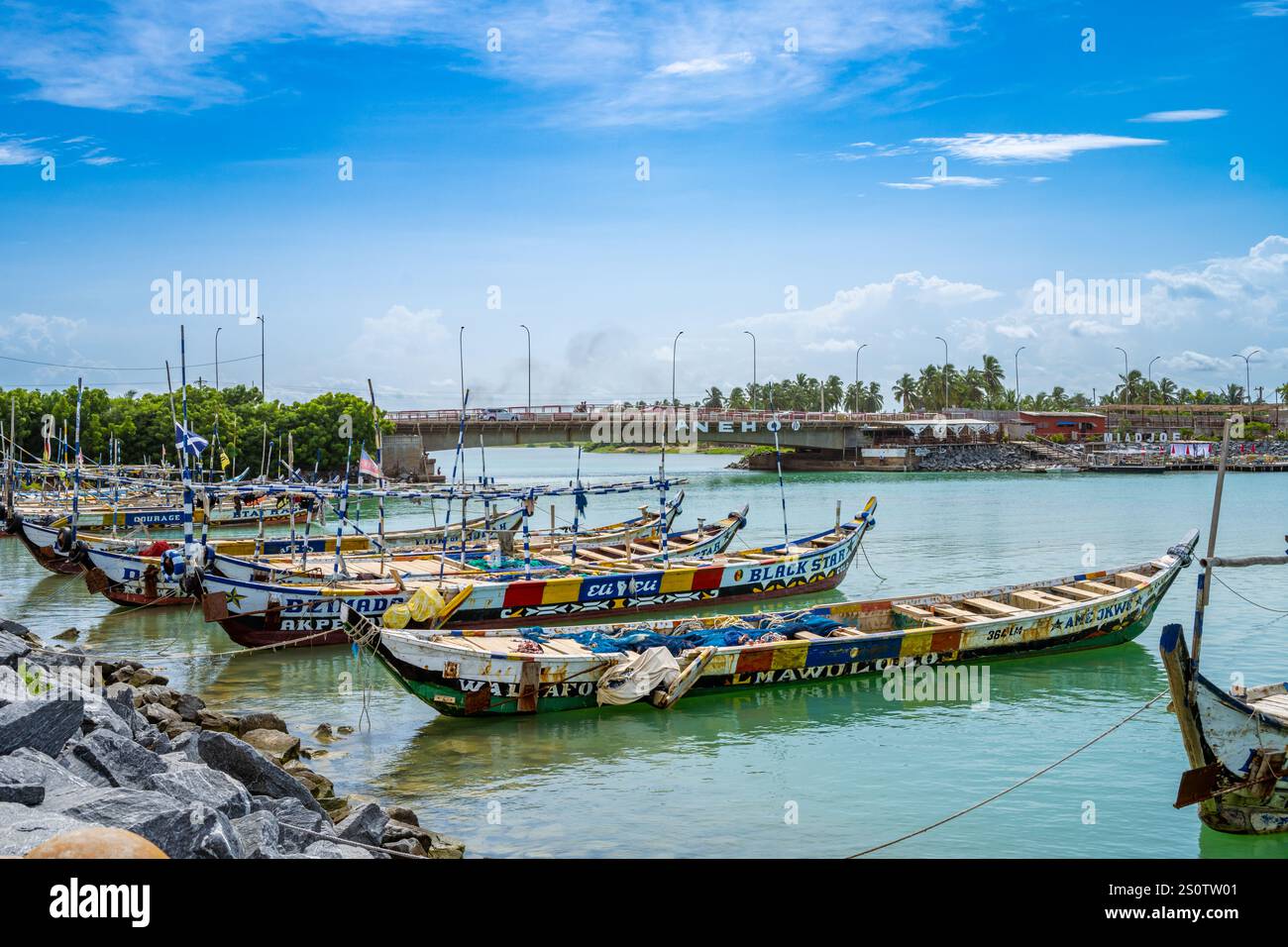 Traditional African fishing colorful fishing boats in port reflecting ...