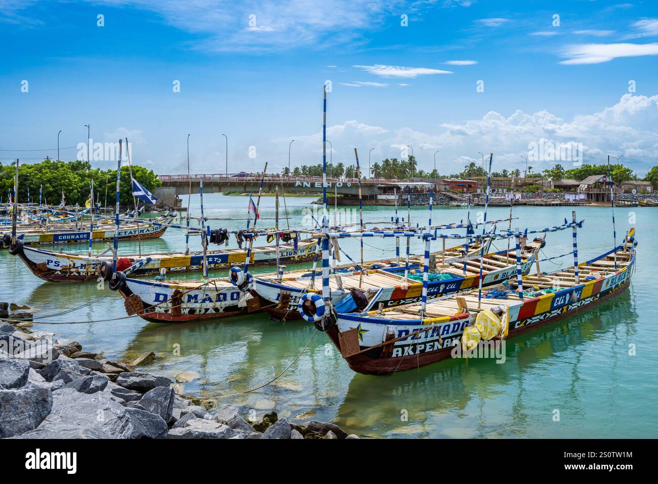 Traditional African fishing colorful fishing boats in port reflecting ...