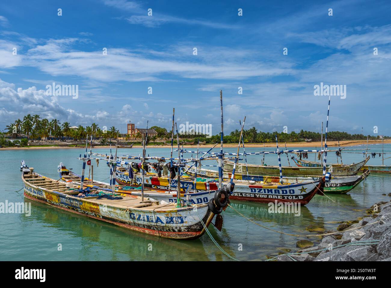 Traditional African fishing colorful fishing boats in port reflecting ...