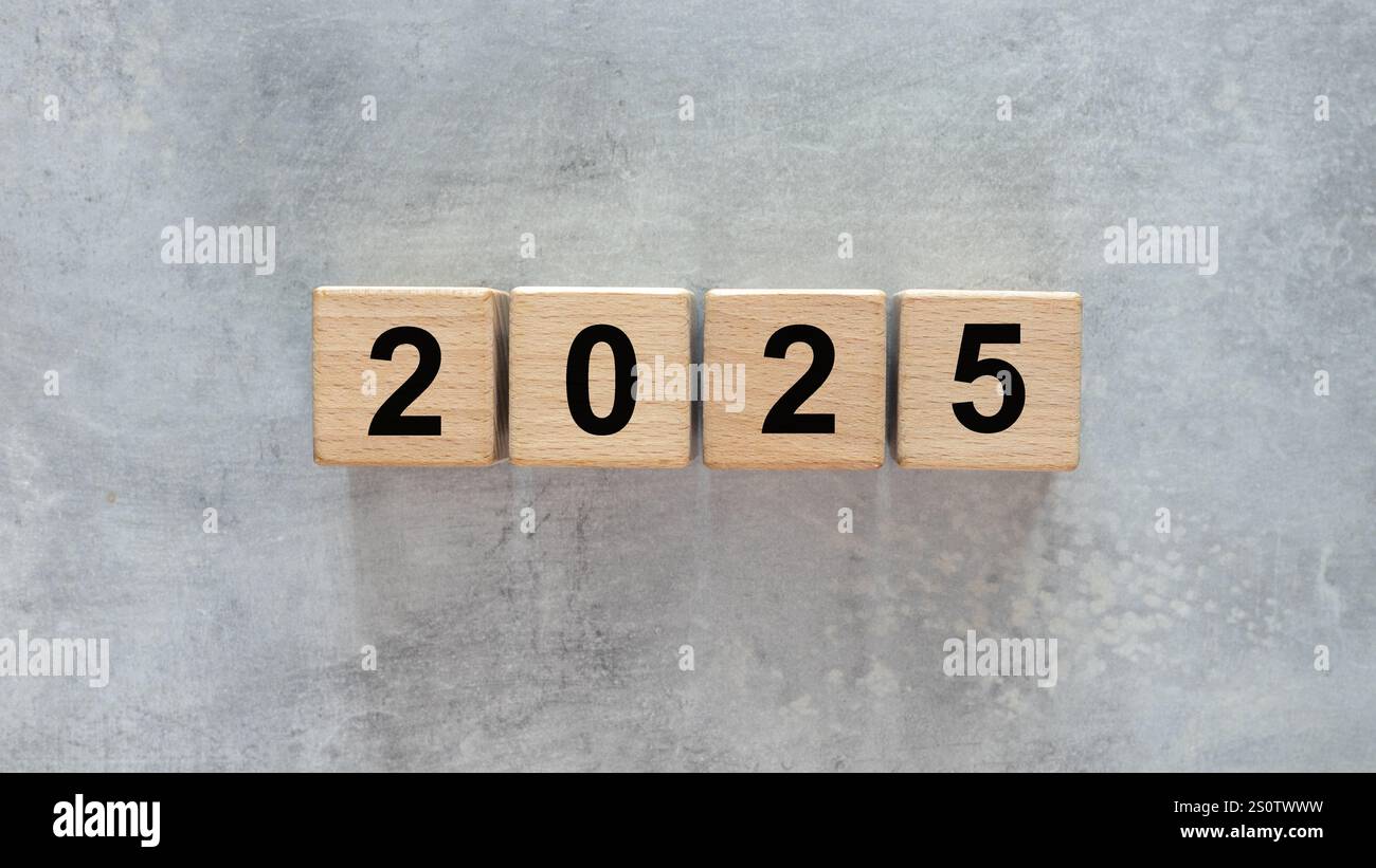 year 2025. Symbol on wooden blocks. date 2025 on a beautiful gray ...