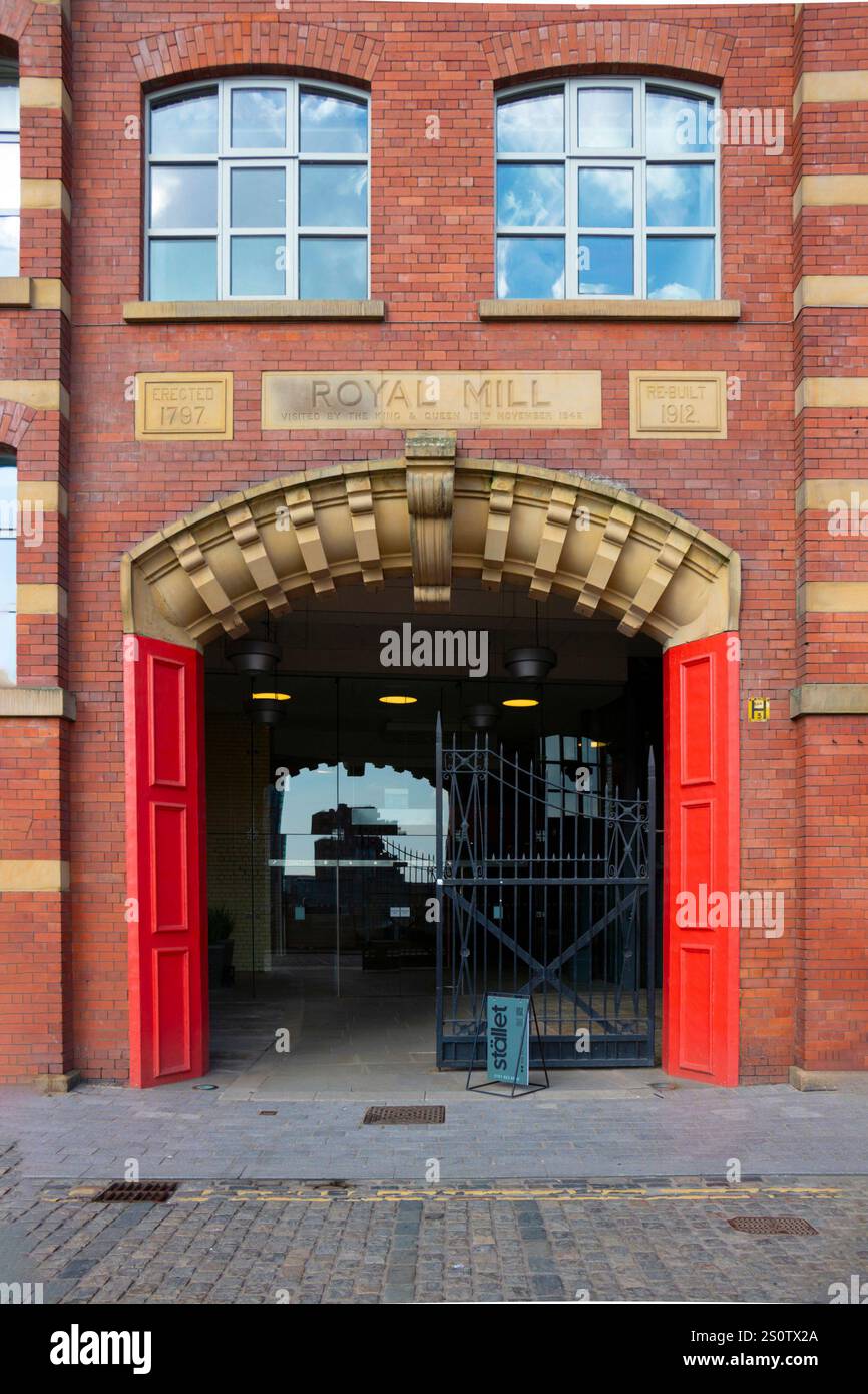 Historic brick facade of the Royal Mill featuring an arched entrance ...