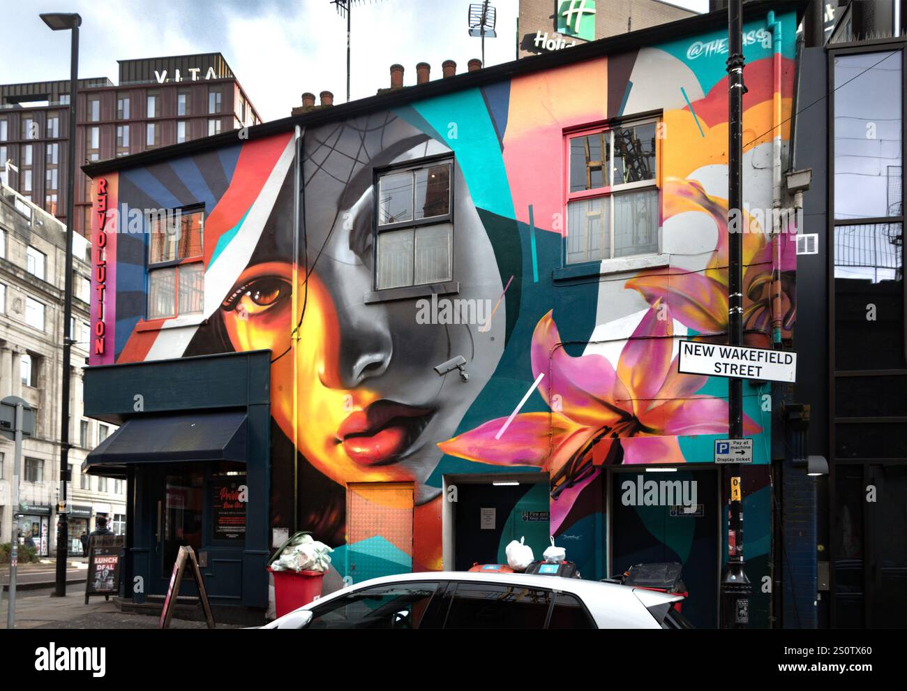 Vibrant street art mural depicting woman's face by street artist Hasan ...