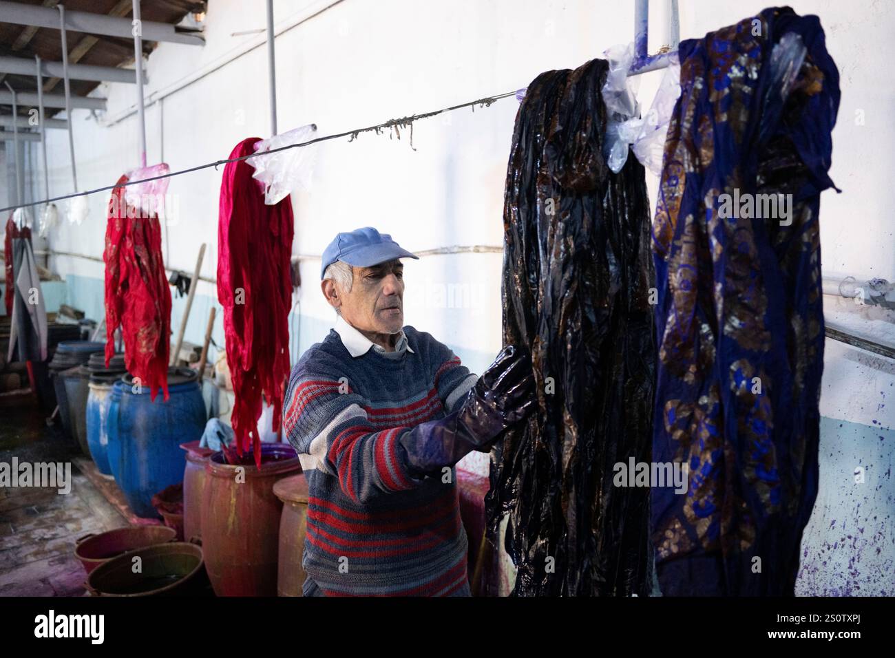 01 November 2024, Azerbaijan, Seki: A Kelaghayi craftsman hangs silk ...
