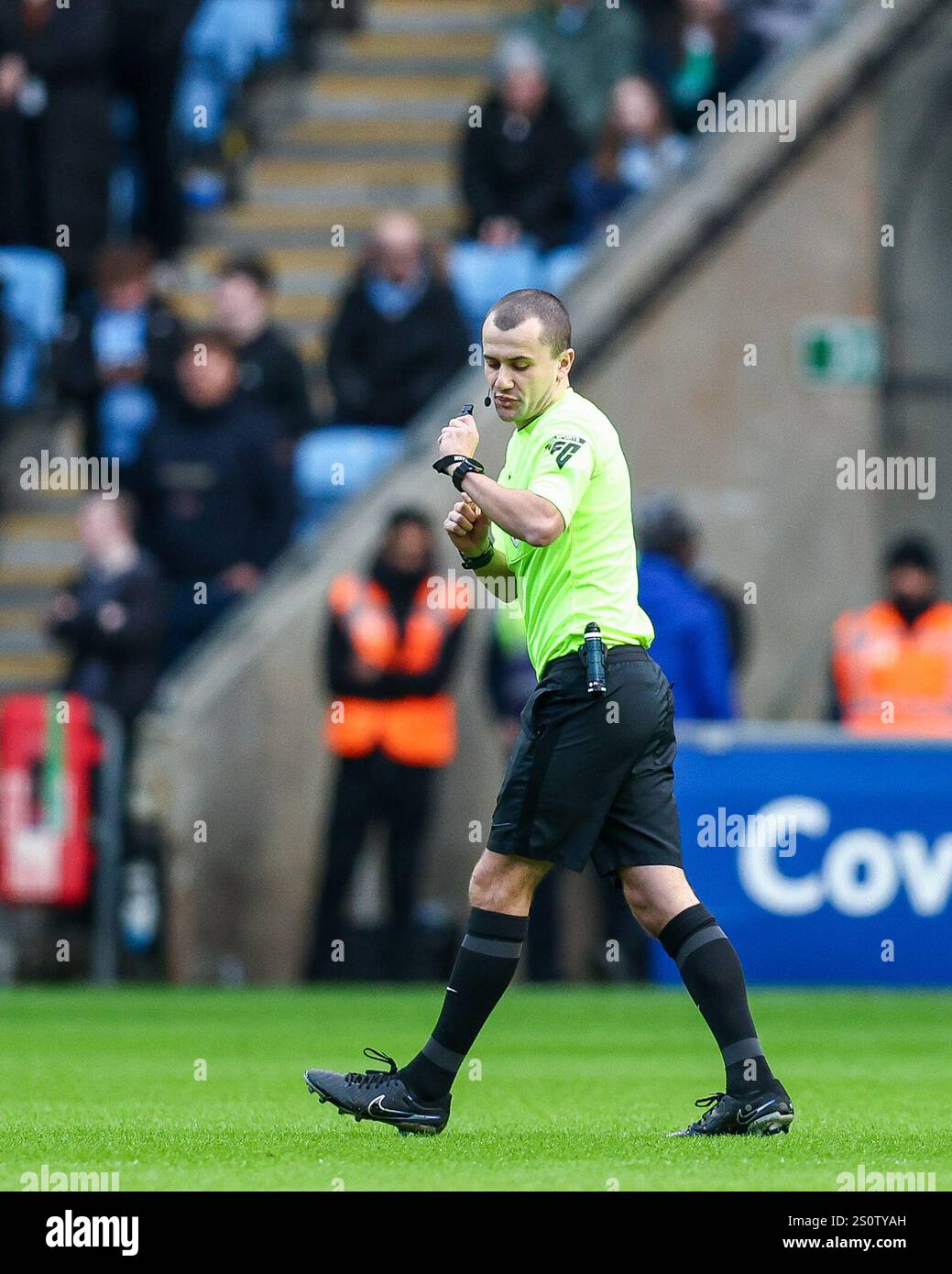 Coventry, UK. 29th Dec, 2024. Referee, Andrew Kitchen checks his watch ...