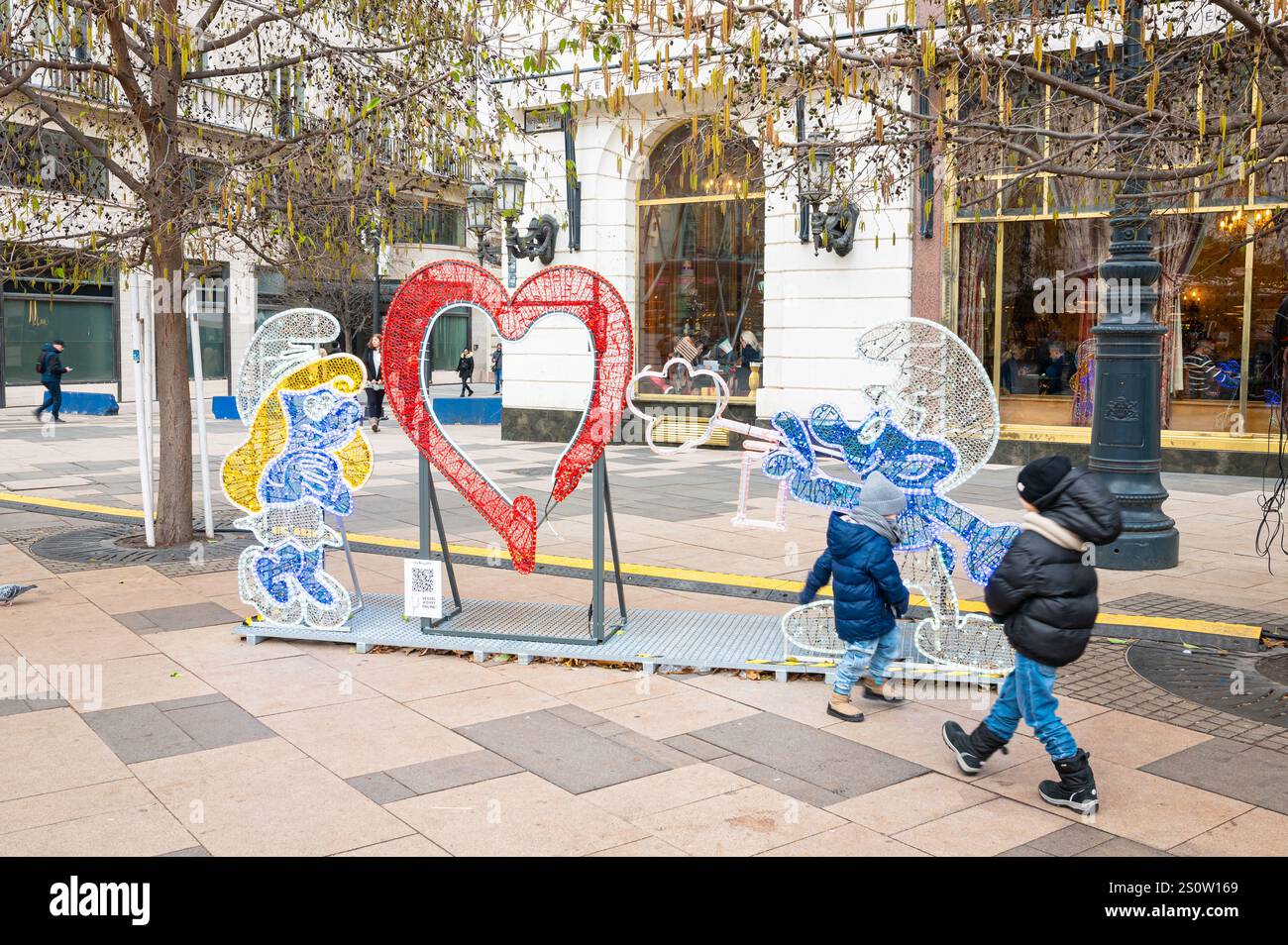 Two children play near a cartoon of smurfs, which can be illuminated at ...