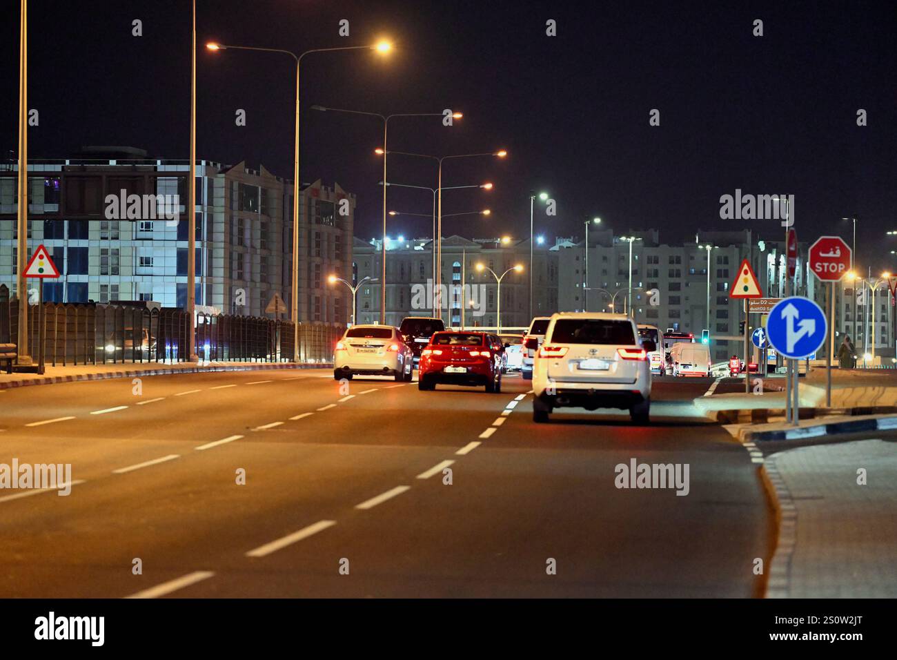 Traffic on a main street in downtown Doha, Qatar on a Saturday night ...