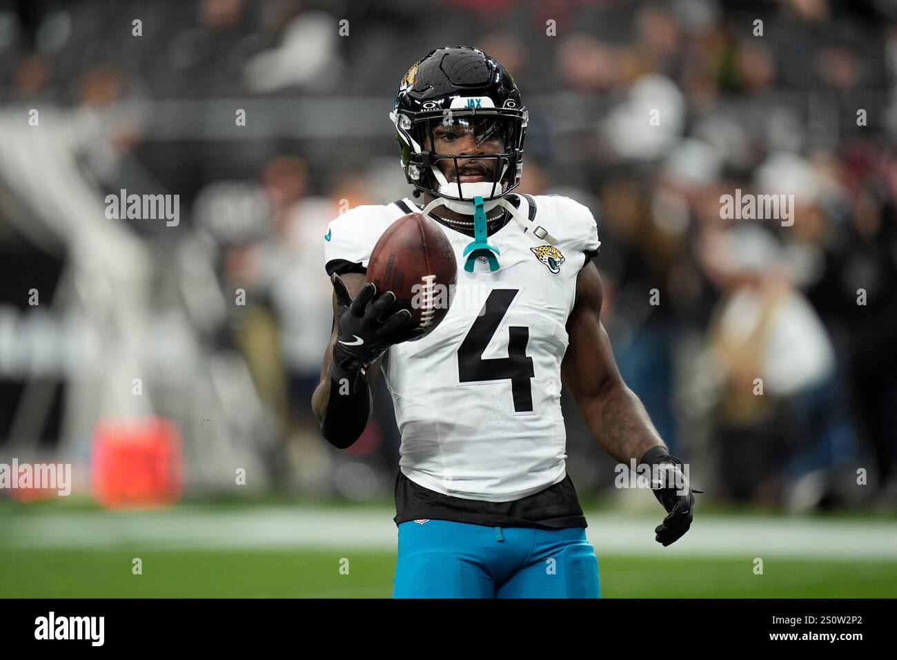 Jacksonville Jaguars running back Tank Bigsby (4) warms up before an ...