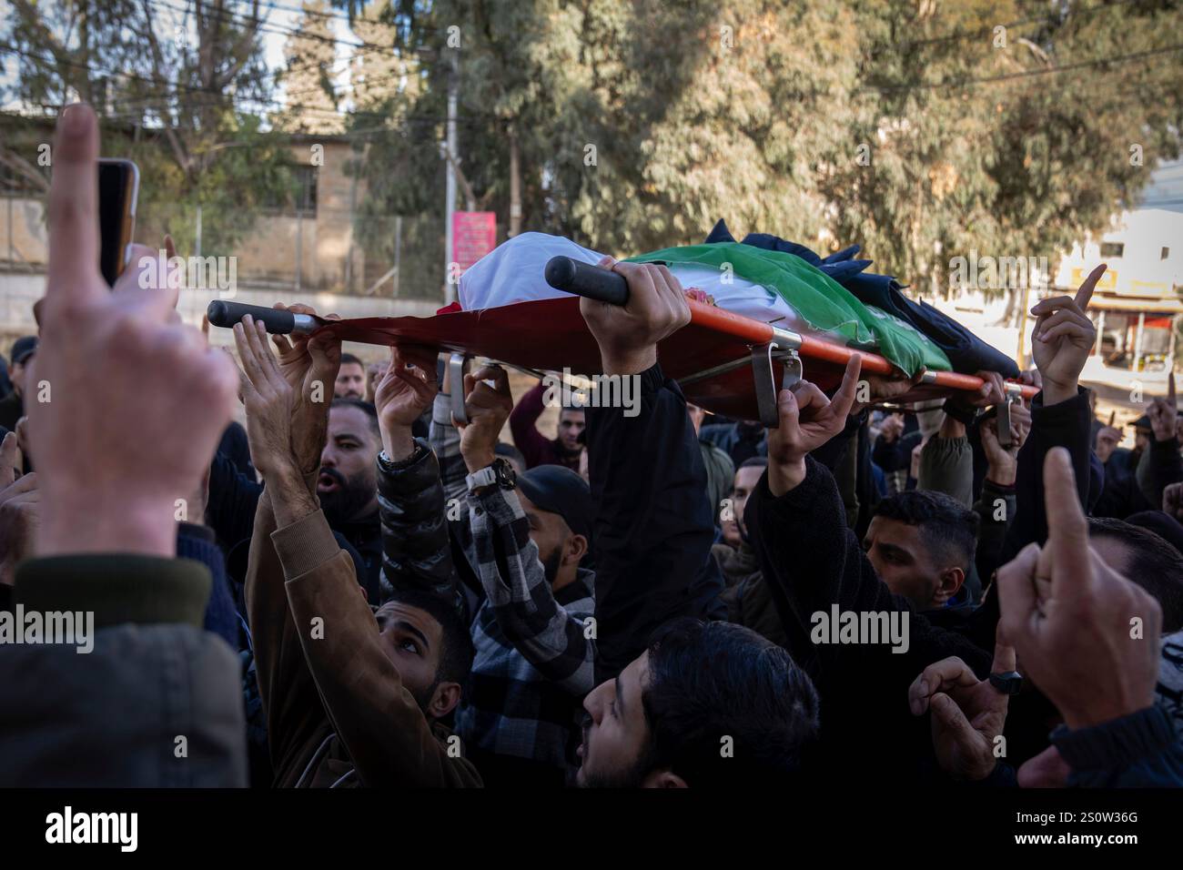 Mourners chant slogans as they carry the body of Palestinian Shatha al ...