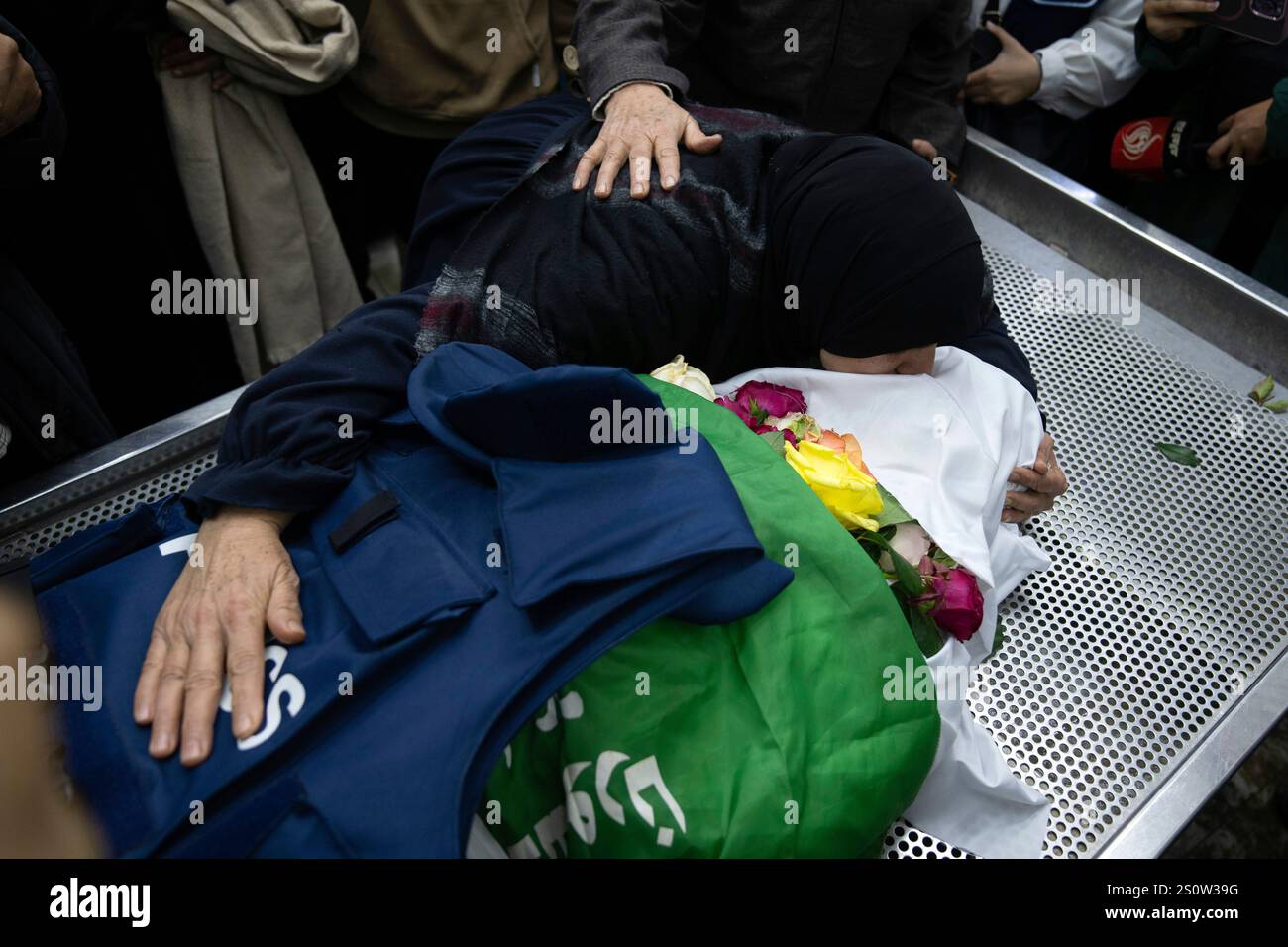 A relative mourns over the body of Palestinian Shatha al-Sabbagh, a 22 ...