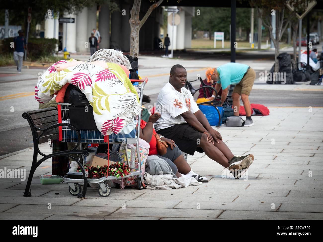 Tampa, Florida, USA. 29th Dec, 2024. A homeless couple rests with their ...