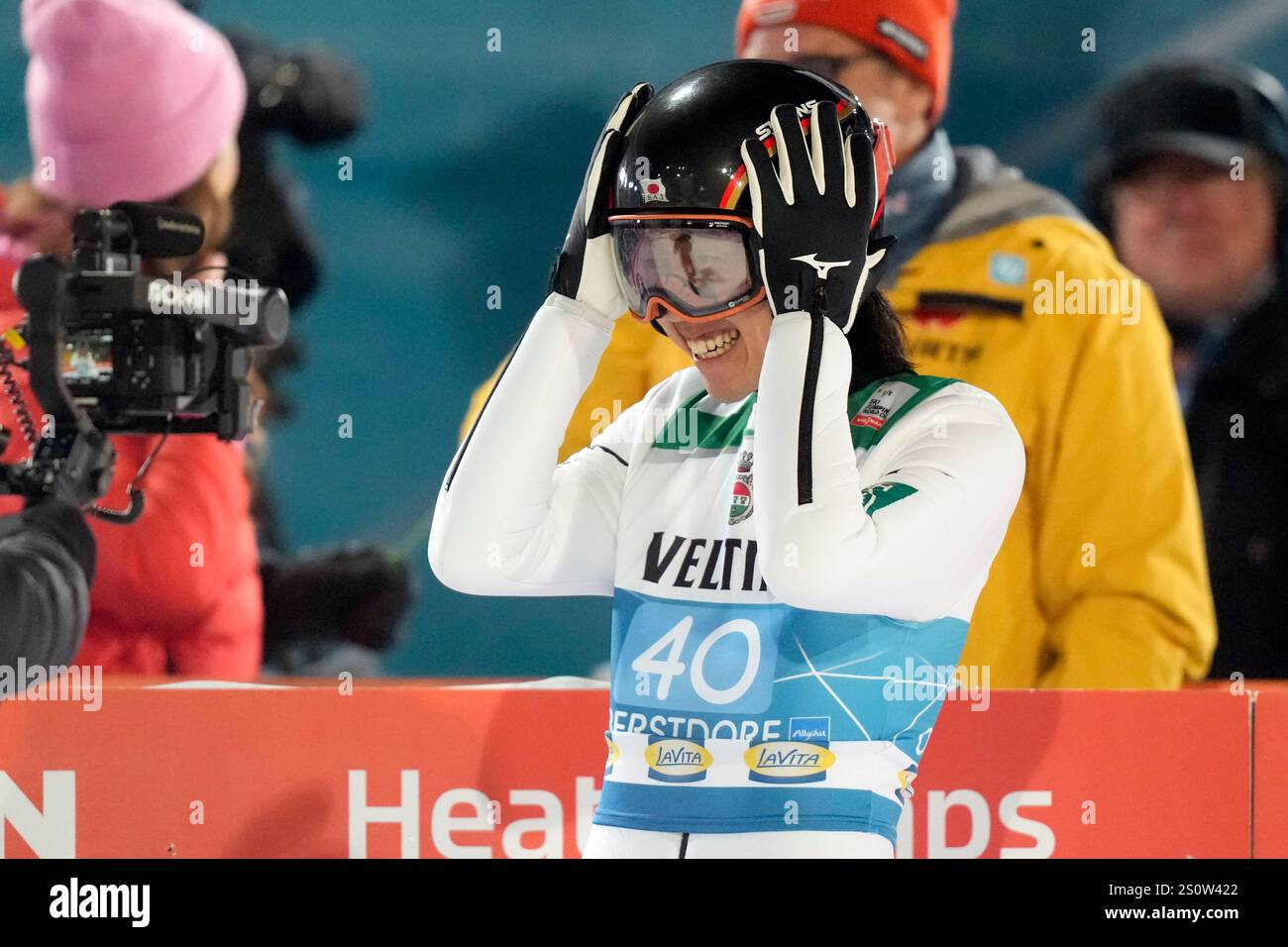 Naoki Nakamura, of Japan, reacts after landing his second round jump at ...
