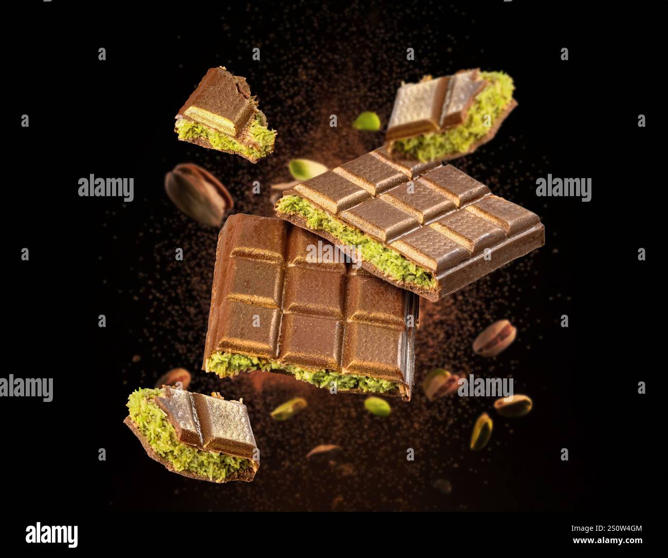 Tasty pistachio chocolate bars exploding on dark background Stock Photo ...