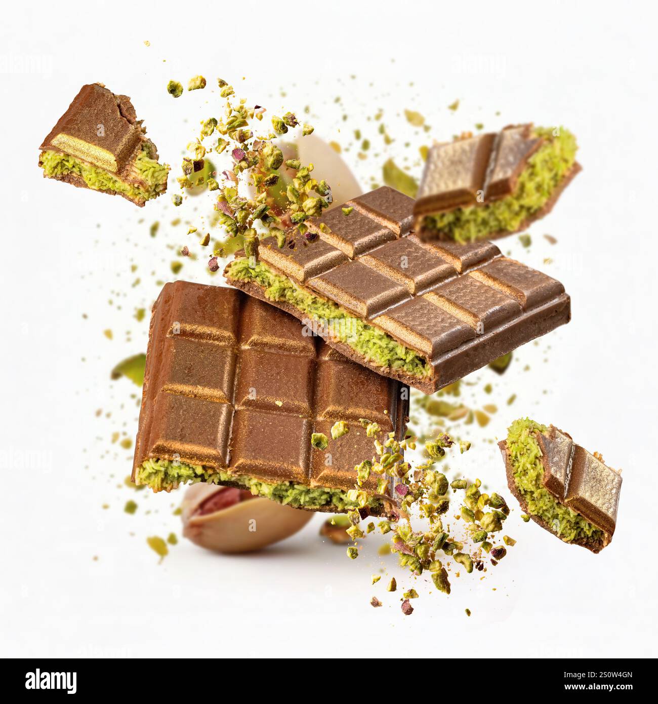 Tasty pistachio chocolate bars exploding on white background Stock ...