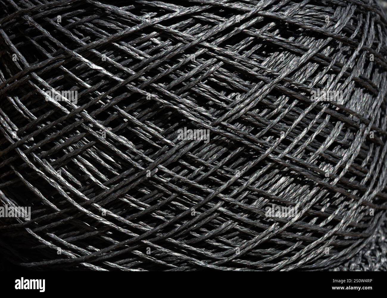 Skein of black raffia. Raffia is an organic wood fiber used to knit ...