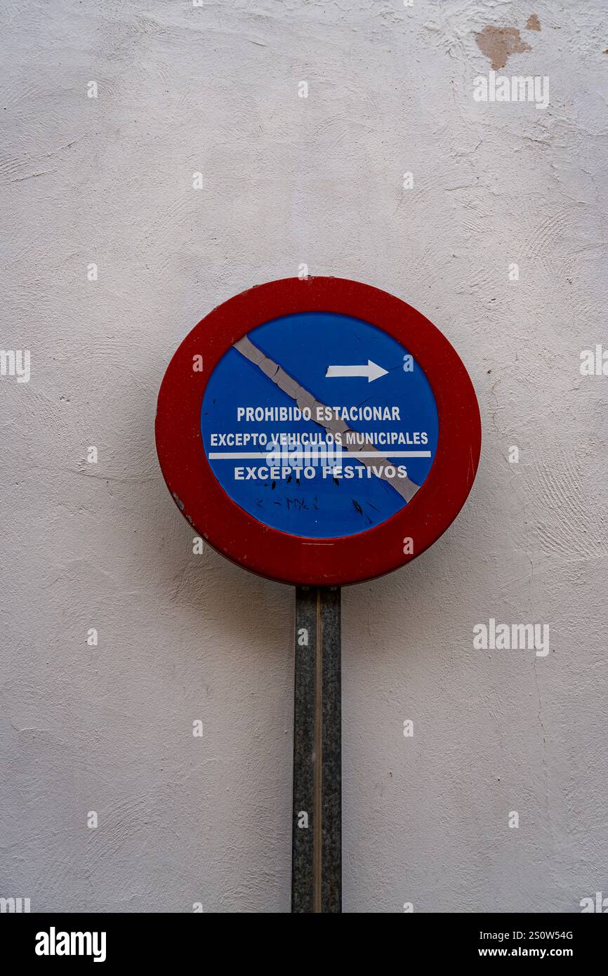 A red and blue sign with a white arrow pointing to the right. The sign ...