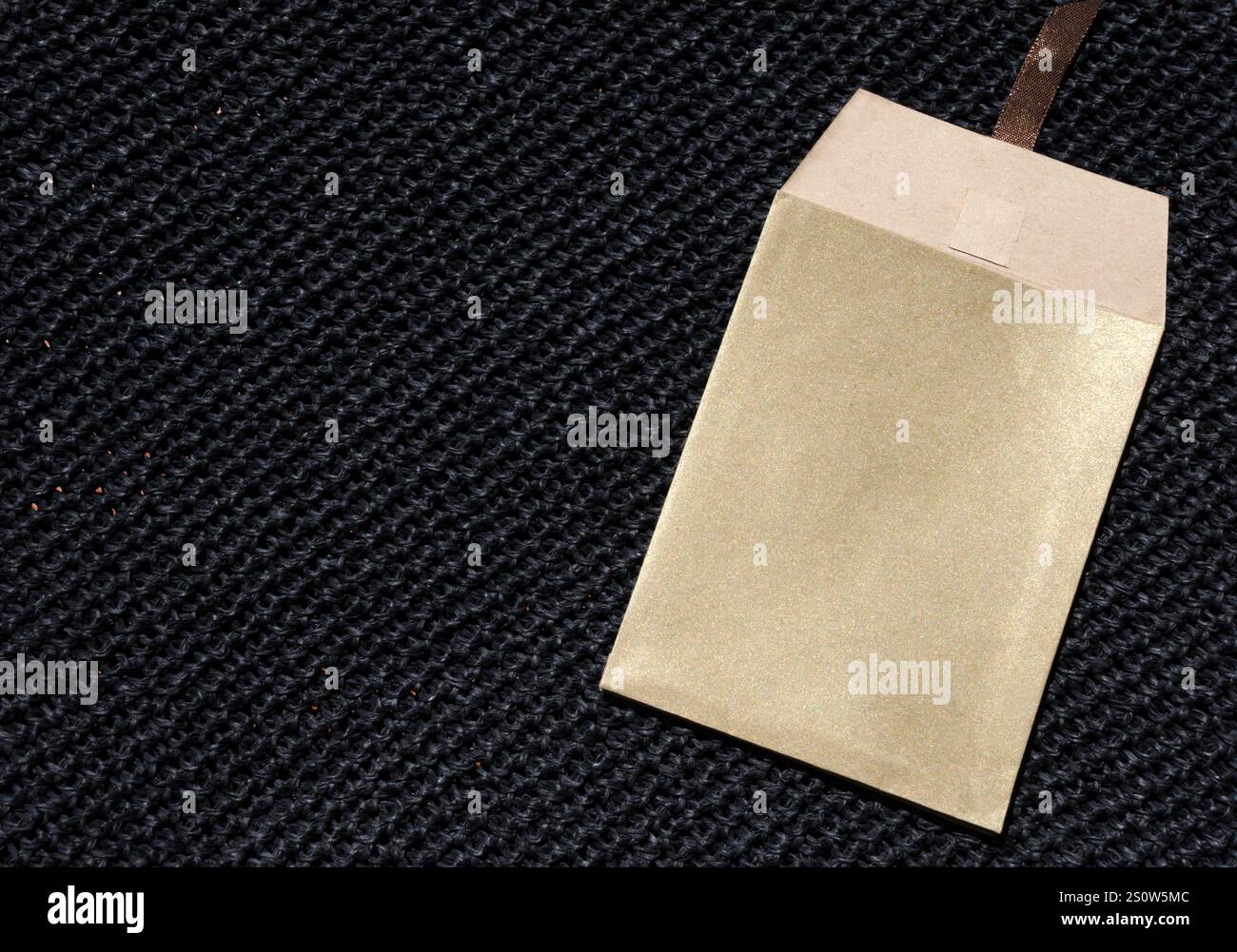 Paper envelope on a seamless knitted pattern. The background is ...