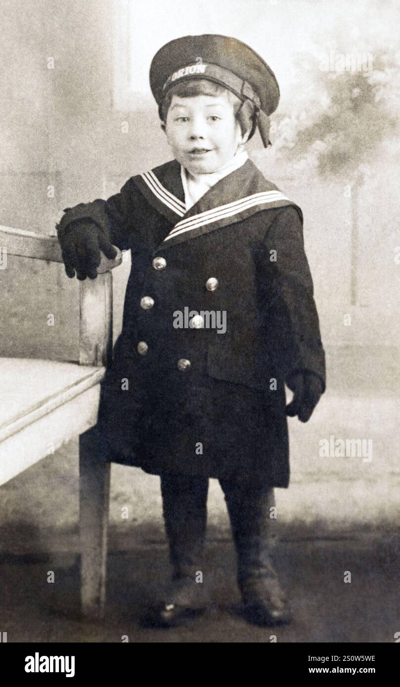 A small boy in a sailor outfit with a cap tally for HMS Orion, c. 1912 ...
