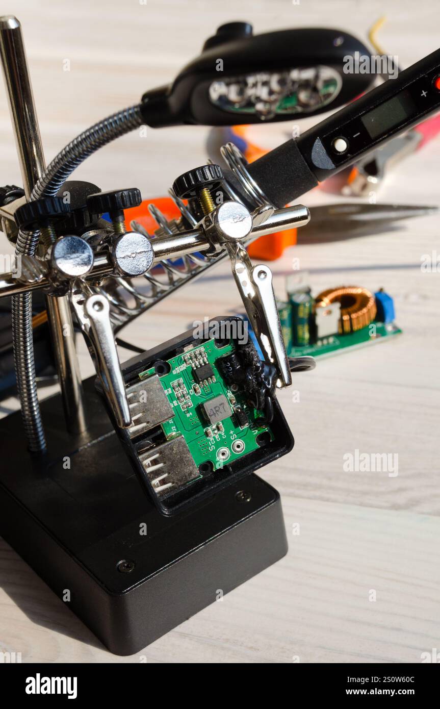 Repair tools with solder clips are third hand. Pliers, knife, wires ...