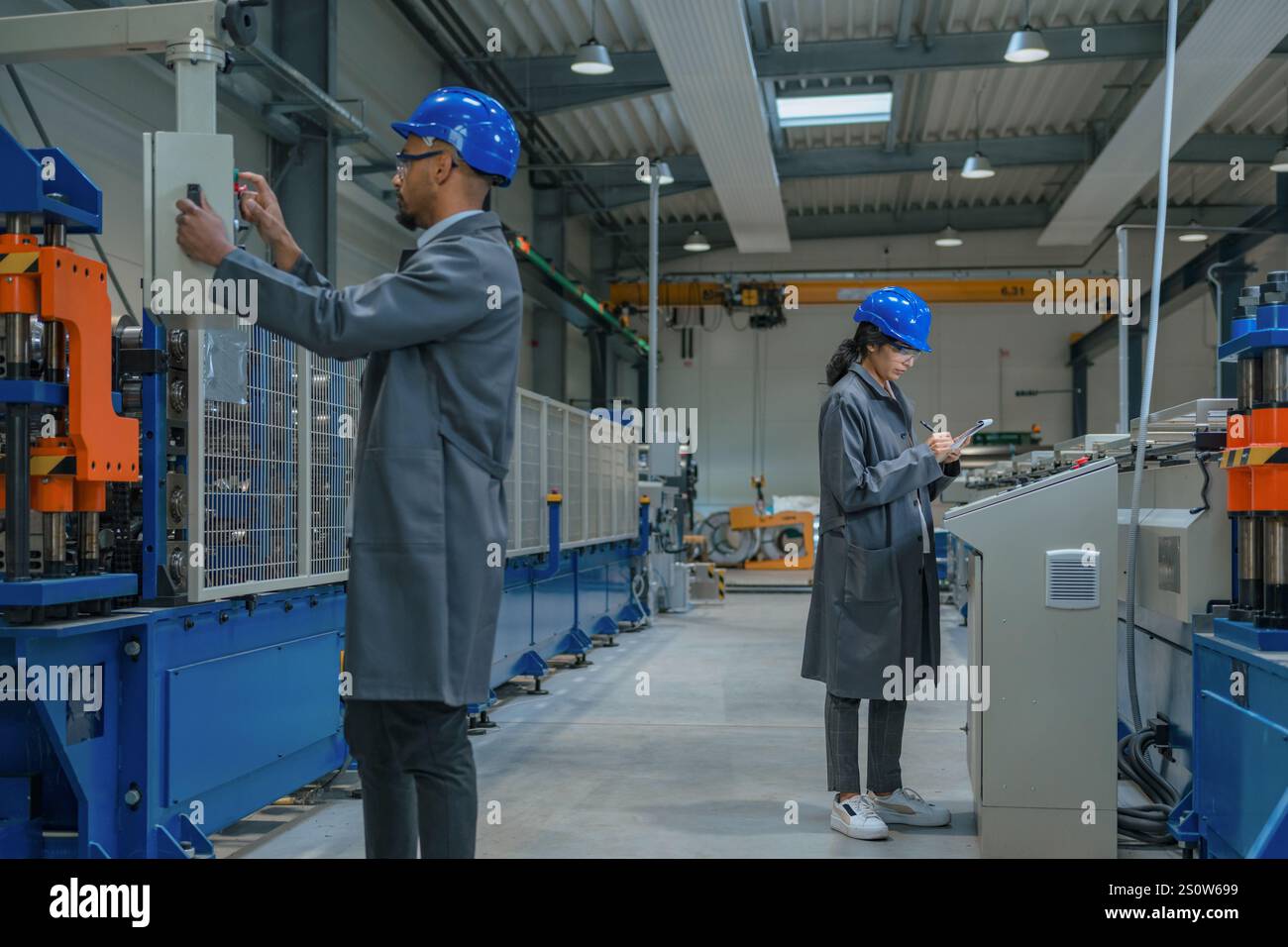 Multiracial engineer team, African American man and Indian woman ...