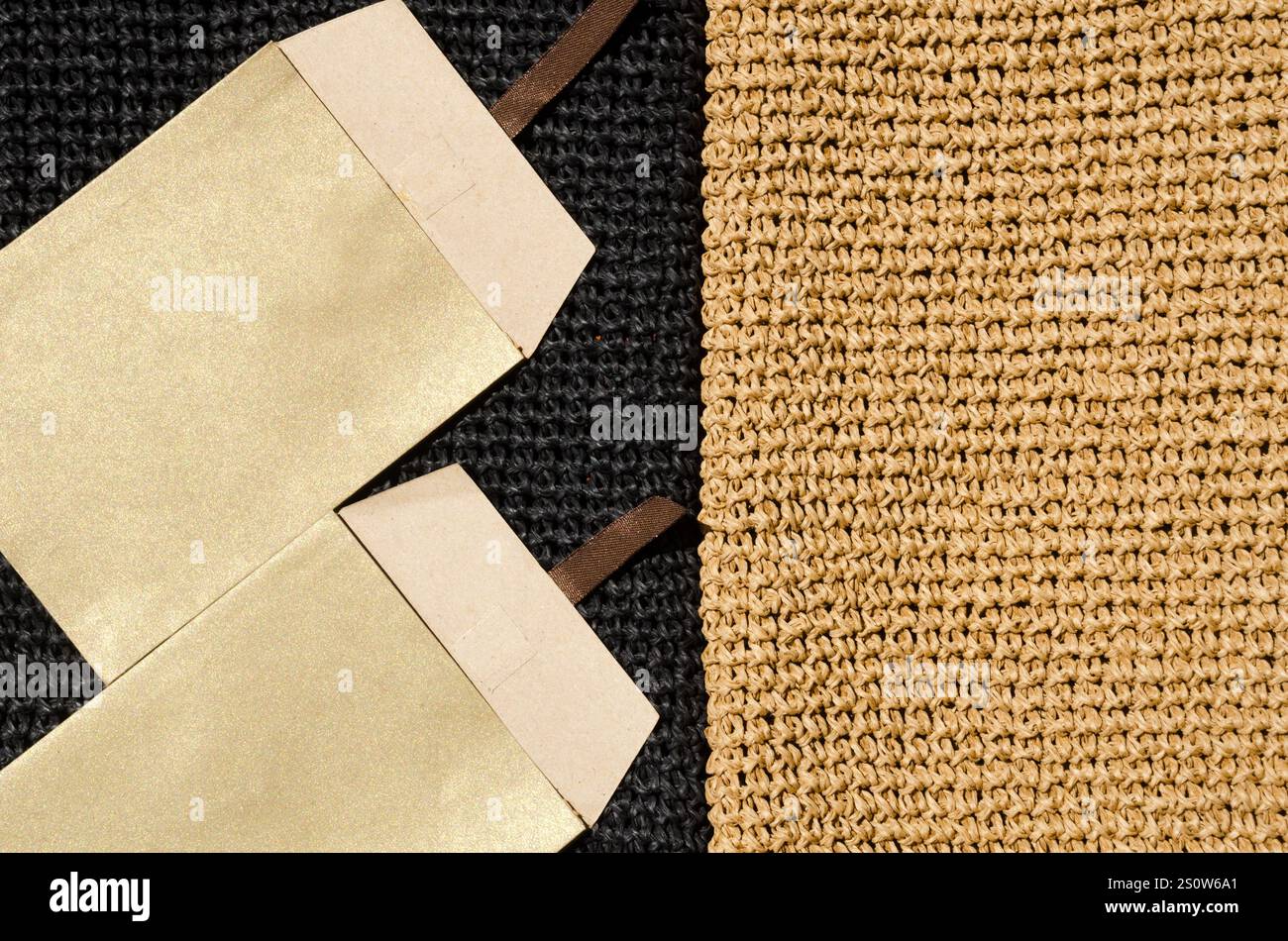 Two paper envelopes on a seamless knitted pattern. The background is ...
