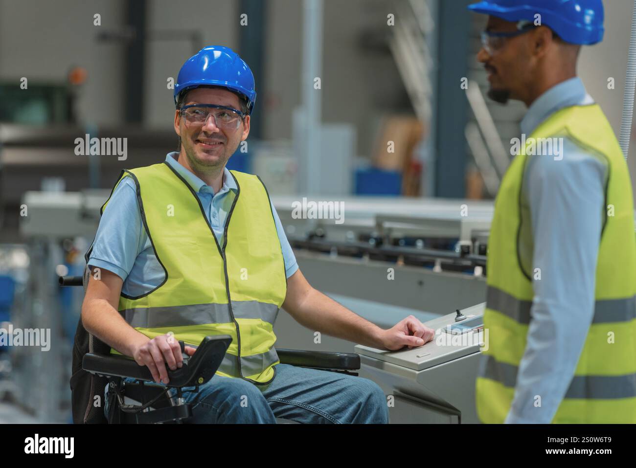 Engineer team, African American man and one with disability manually controlling automated ...
