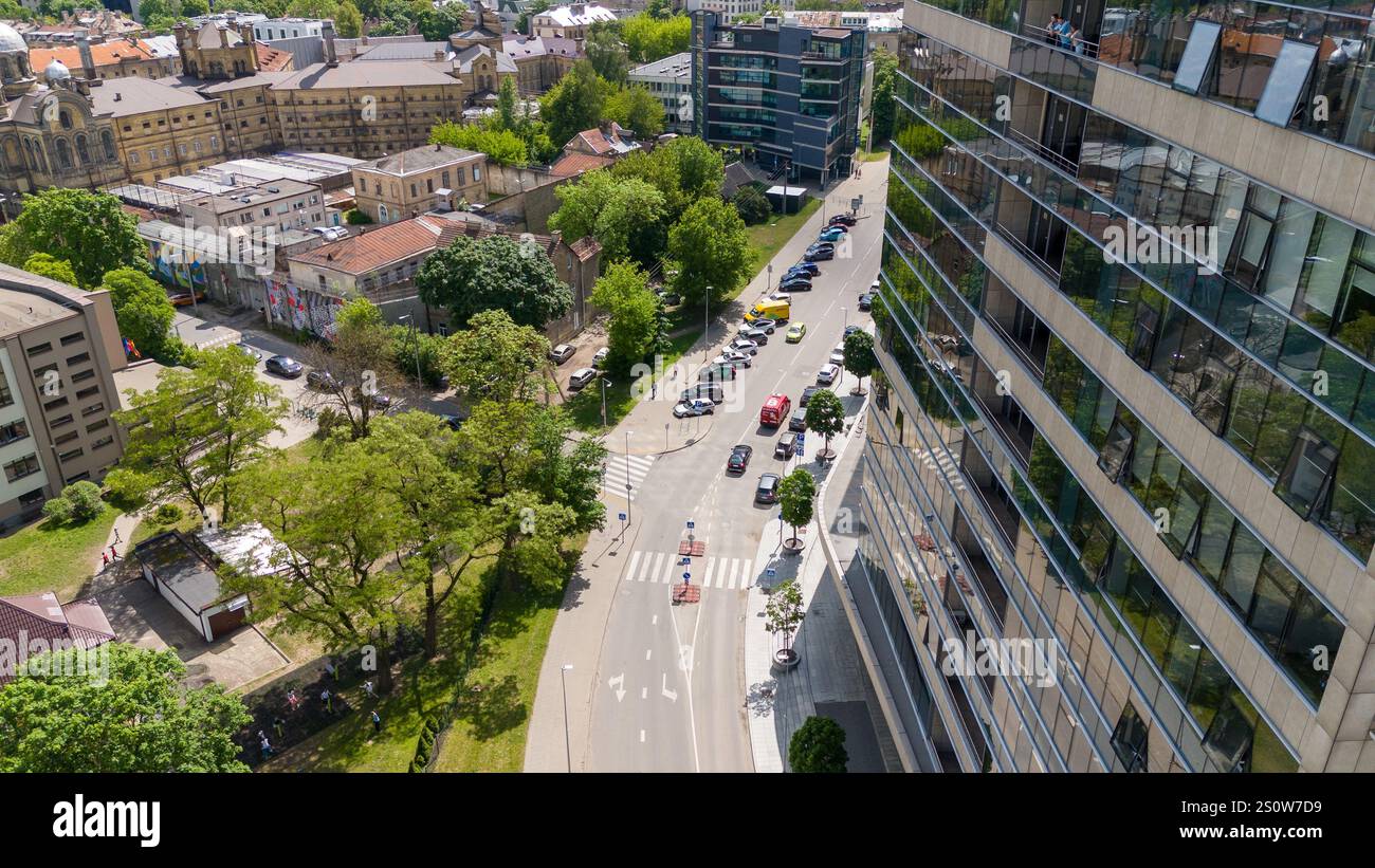 Aerial view of a modern urban area with a glass office building, street ...