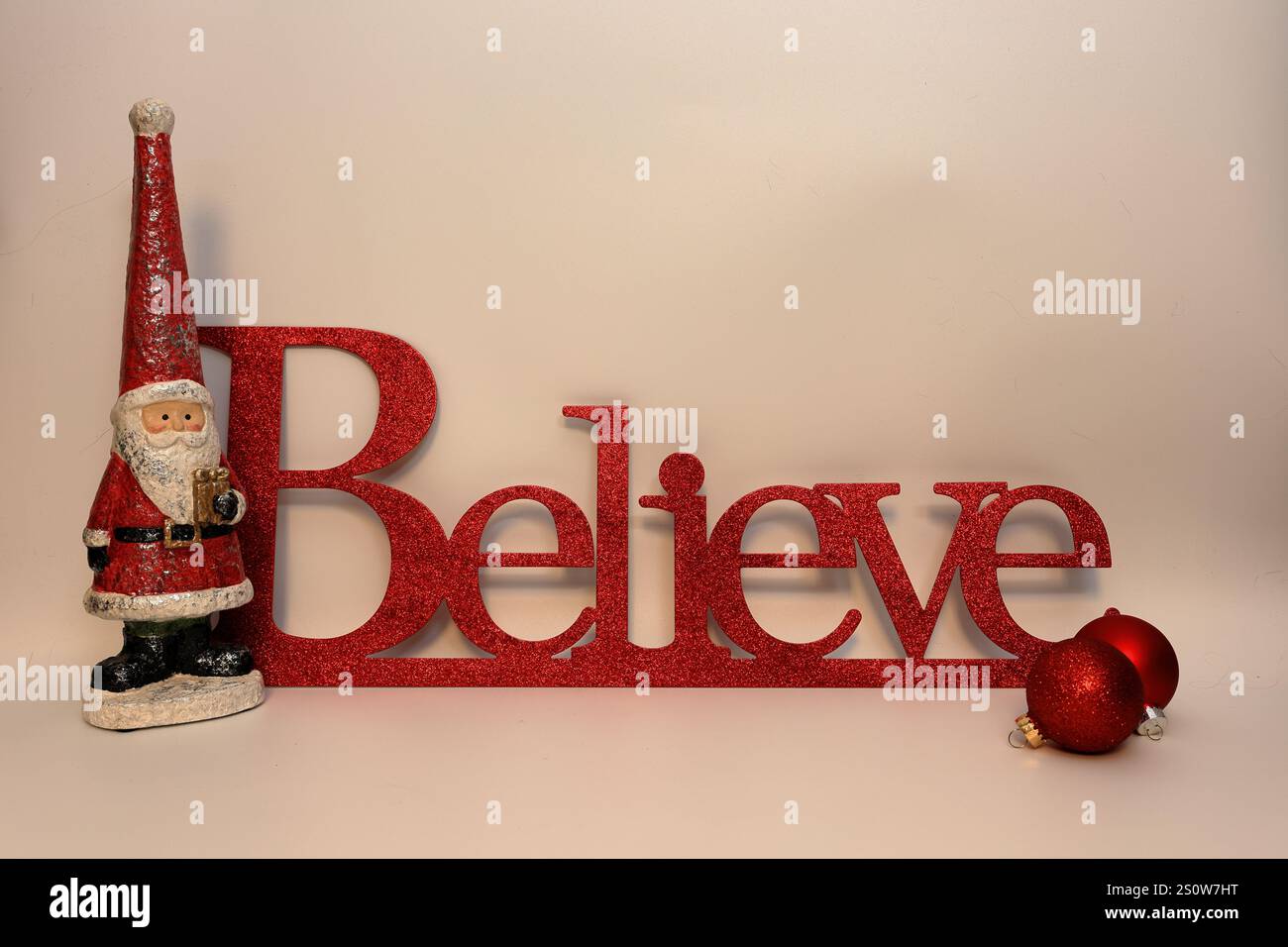 The word Believe next to Santa Clause with a clean white background ...