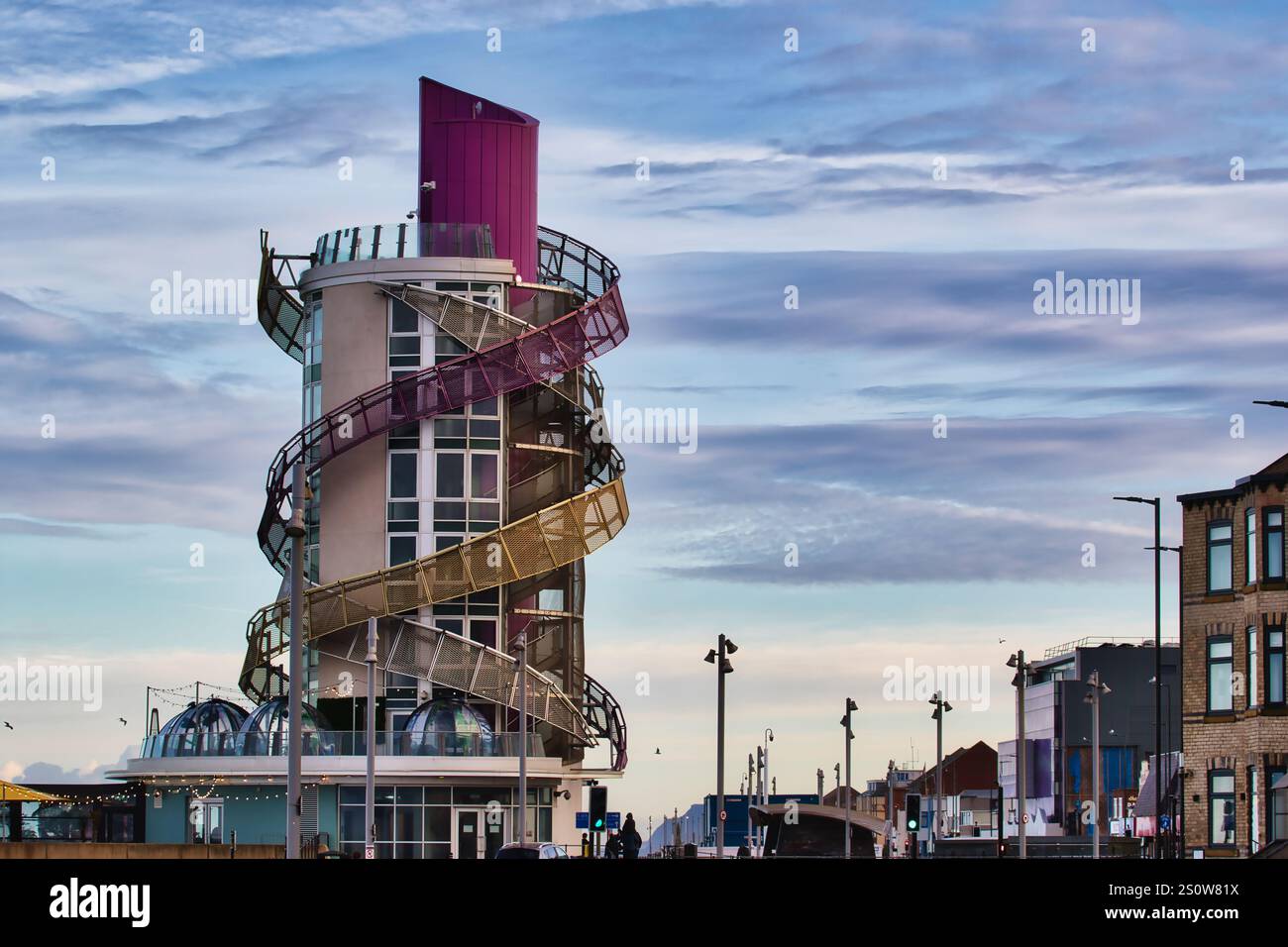 A multi-story building with a prominent spiral slide wraps around its ...