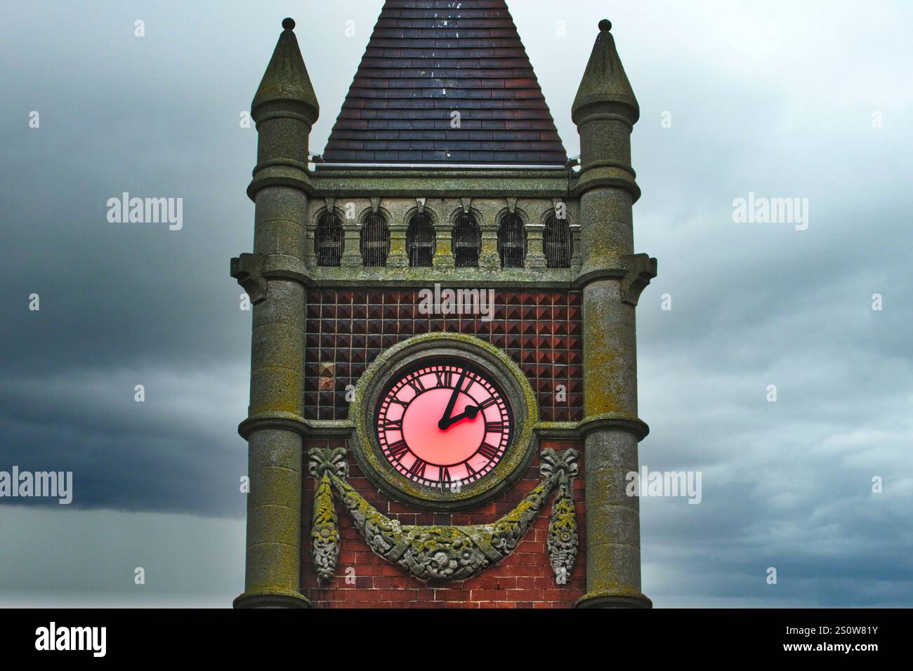 A close-up view of a clock tower's upper section, featuring a pink ...