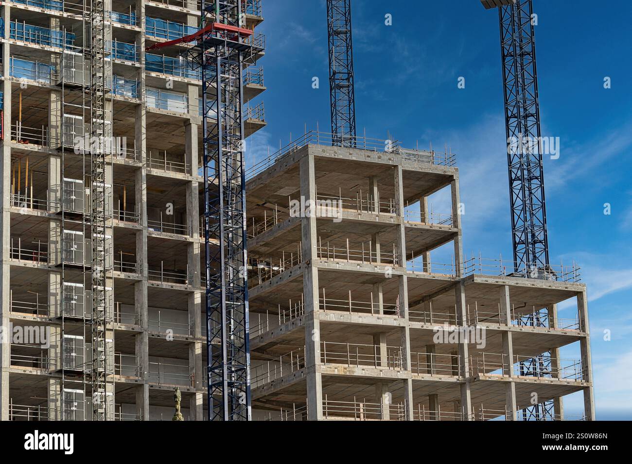 Two adjacent high-rise buildings under construction. Concrete ...