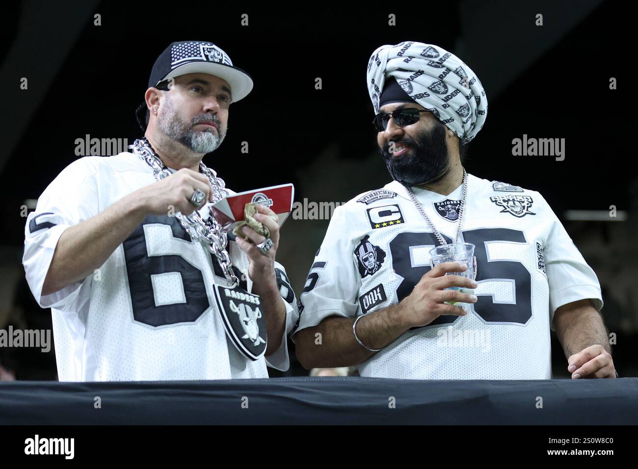 A couple of Las Vegas Raiders fans chat during a National Football ...