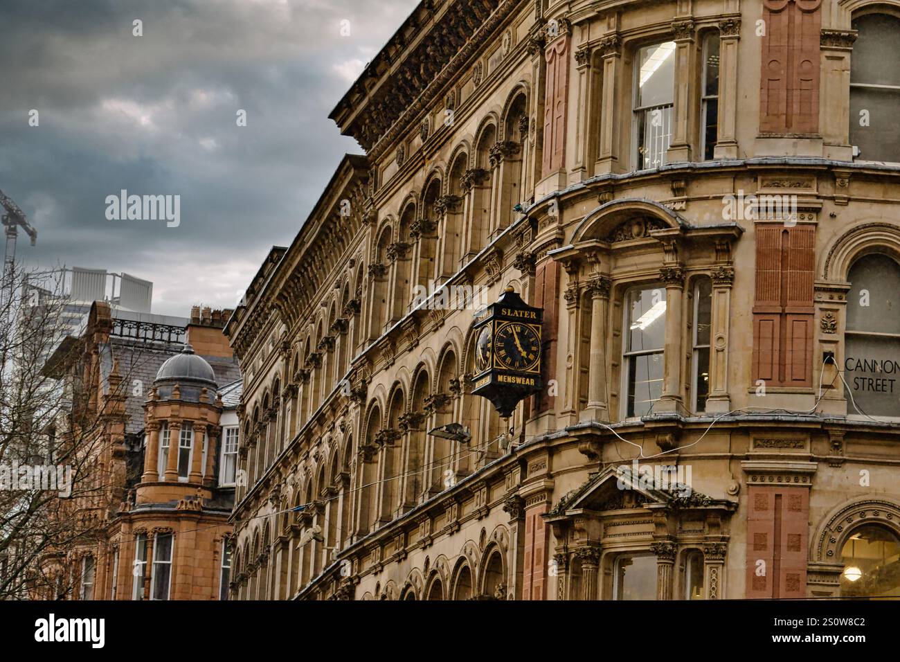 A tan-colored Victorian-era building with an ornate facade, arched ...