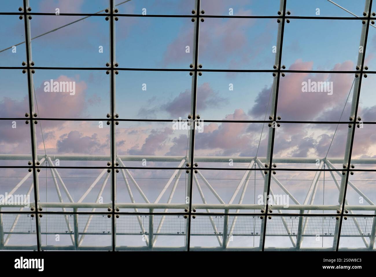 Glass ceiling panels and a supporting metal framework viewed from below ...