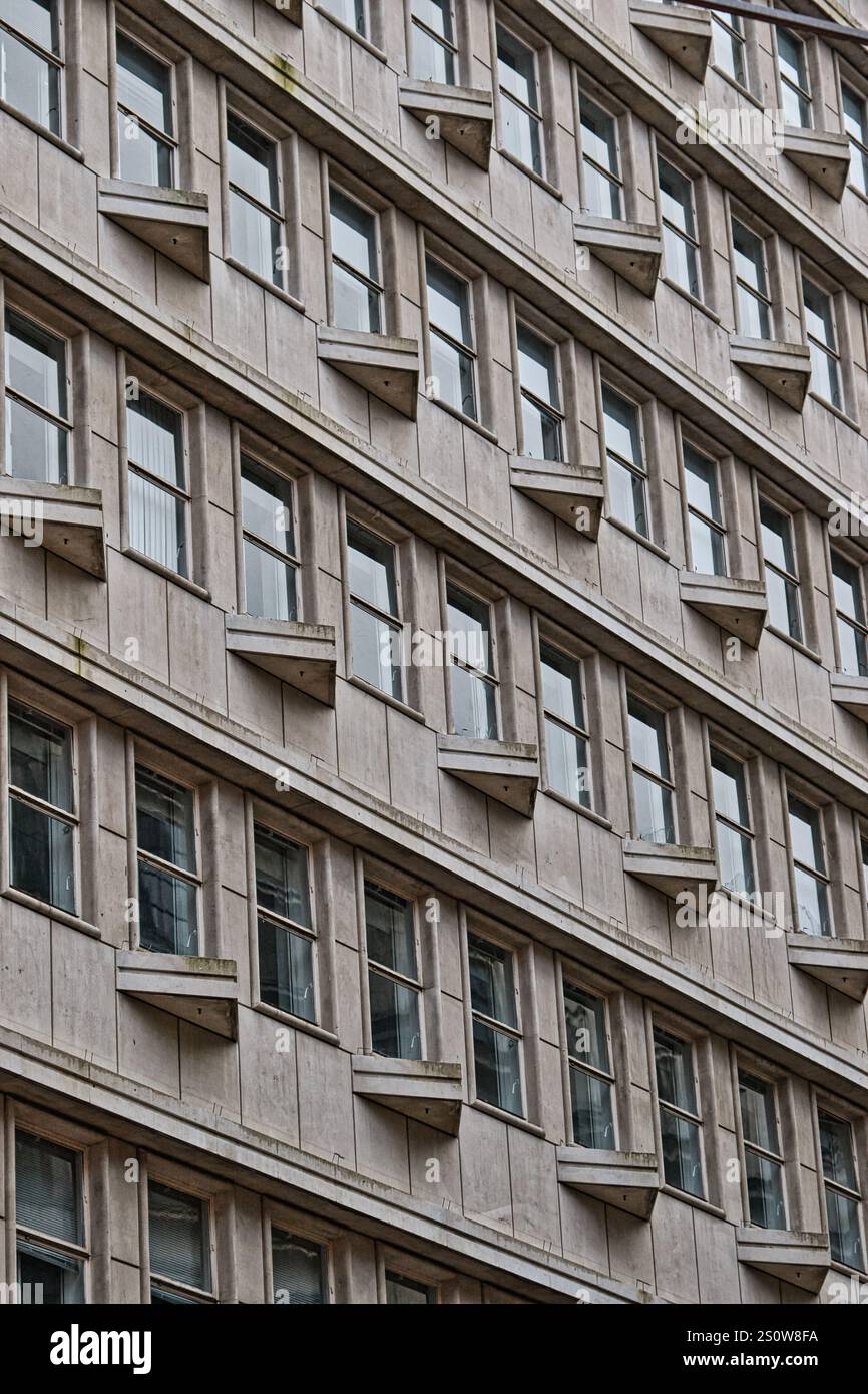 A high-angle, close-up view of a multi-story building's exterior ...