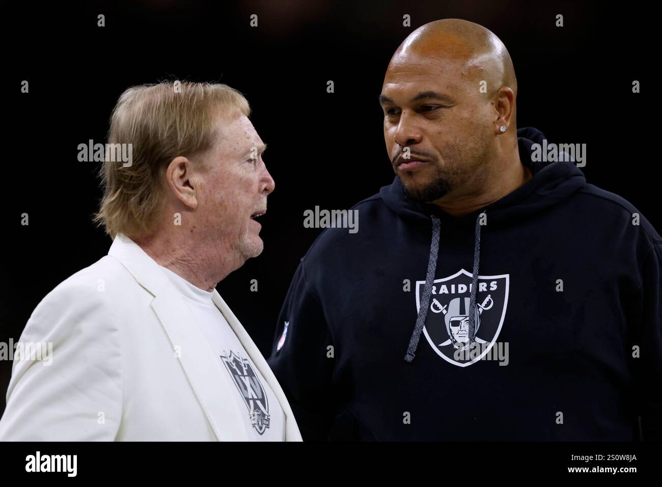 Las Vegas Raiders owner Mark Davis, left, talks with head coach Antonio ...