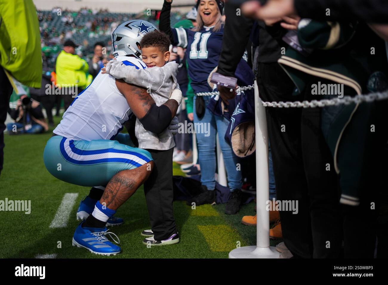 Dallas Cowboys linebacker Micah Parsons hugs his son, Malcolm, prior to ...