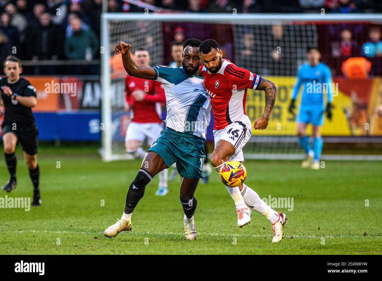 Morecambe FC's Jordan Slew is beaten by Curtis Tilt of Salford City FC ...