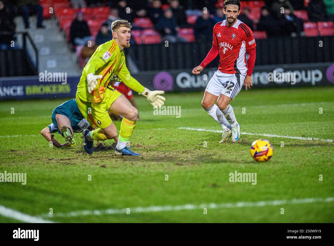 Morecambe FC's Gwion Edwards misses the shot across goal as Matt Young ...