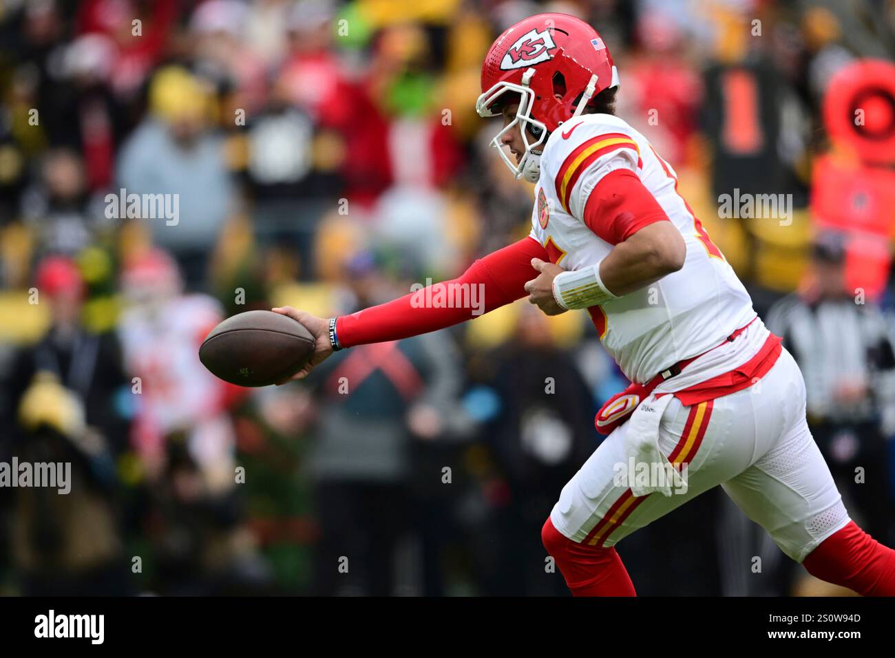 Kansas City Chiefs quarterback Patrick Mahomes turns to hand off during ...