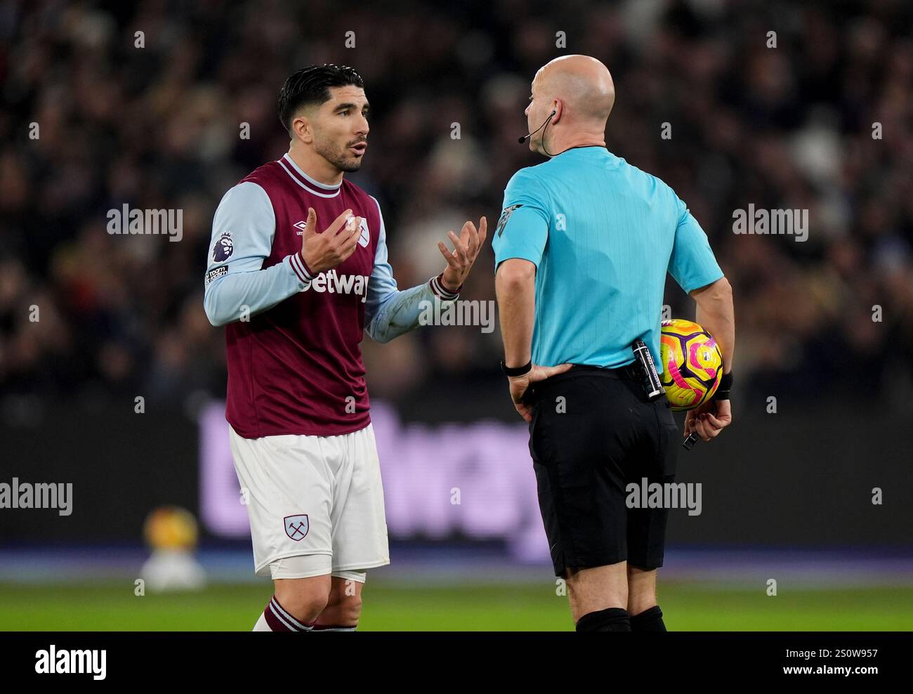 West Ham United's Carlos Soler (left) speaks with referee Anthony ...