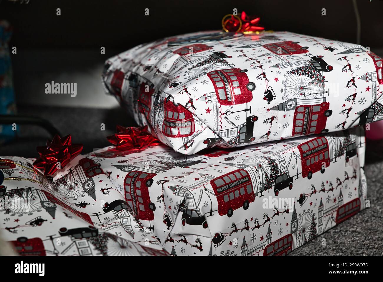 Two Christmas gifts wrapped in white paper featuring a London-themed ...