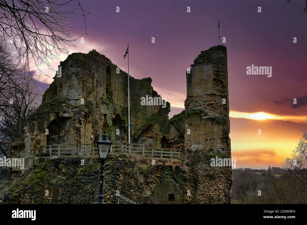 Ruins of a stone castle at sunset. The castle walls are partially ...