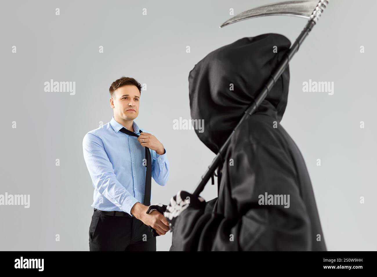 Young upset business man shaking hand making a deal with devil on ...