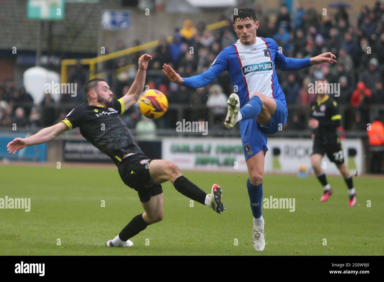 Accrington Stanley's Ben Woods fouls Carlisle United's Cameron Harper ...