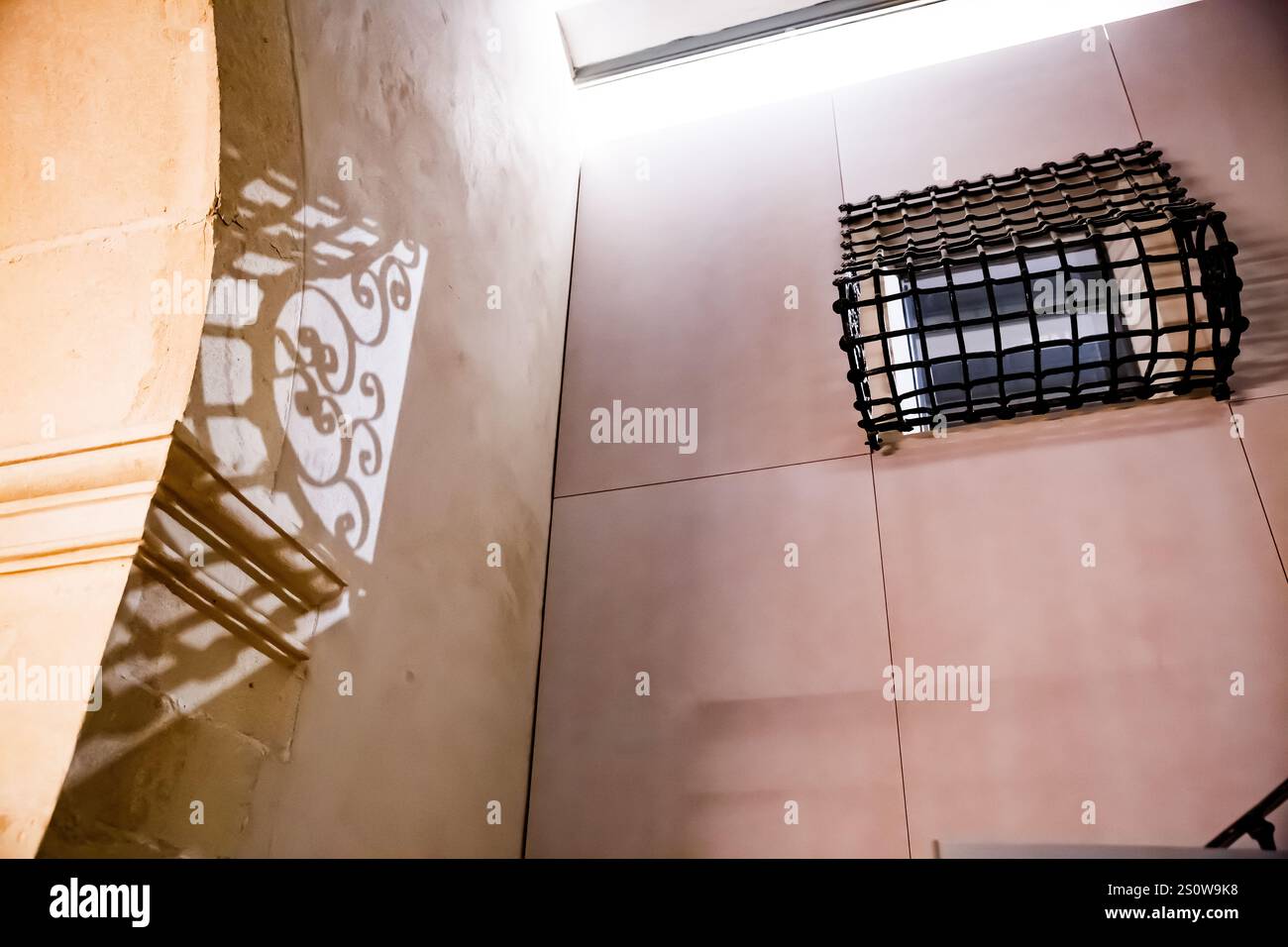 Window with the shadow of its grille on the wall in Alicante Stock ...