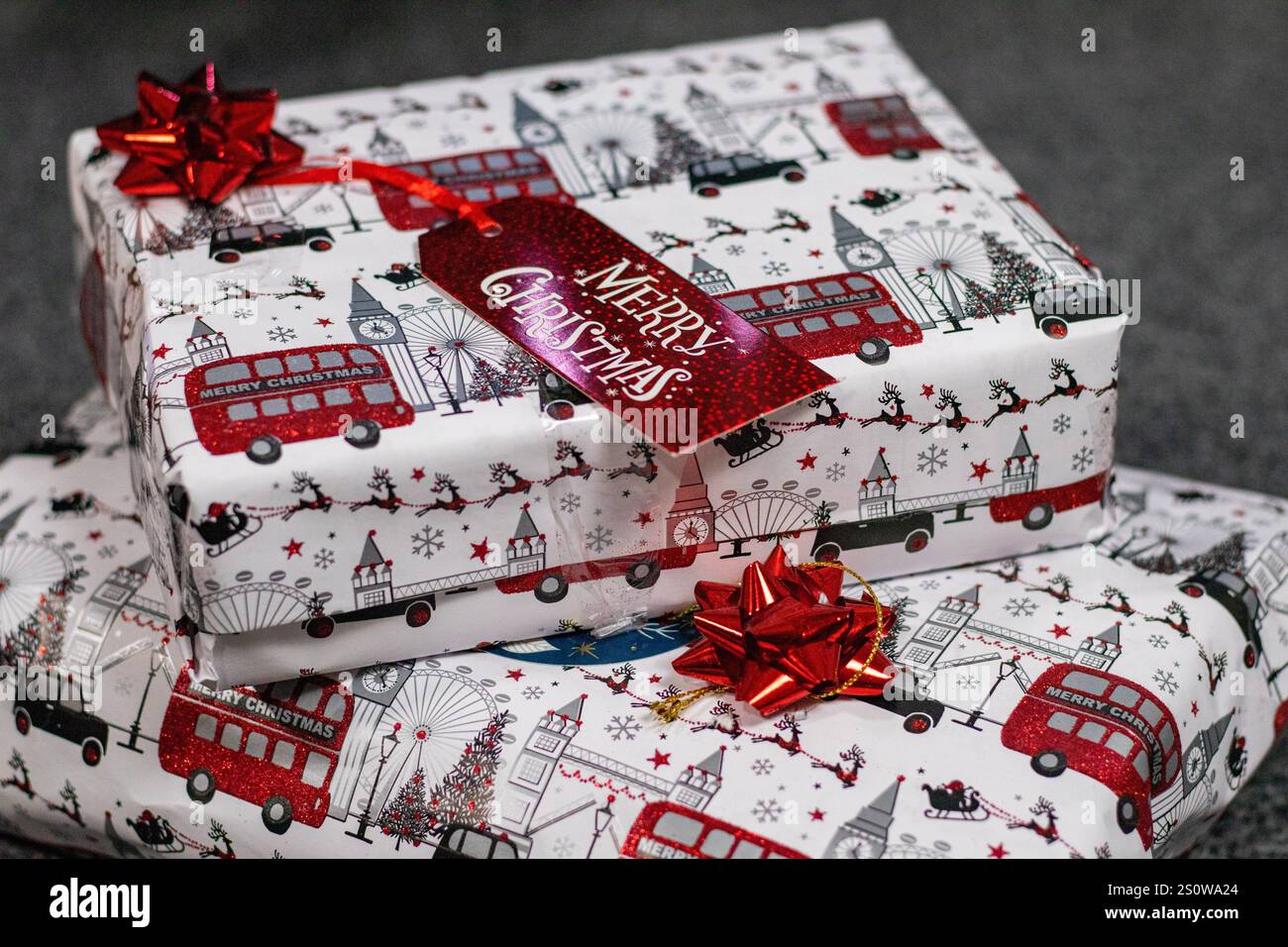 Two Christmas gifts wrapped in London-themed paper featuring red double ...