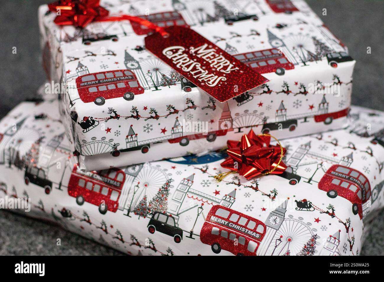 Two Christmas gifts wrapped in white paper featuring a London theme ...