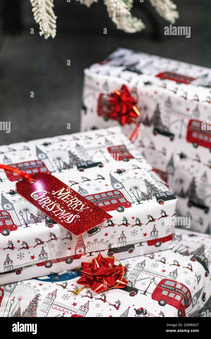 Three Christmas presents wrapped in white paper with a London theme ...