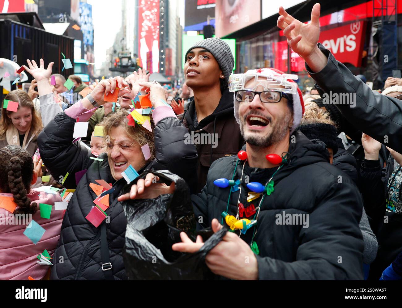 New York, United States. 29th Dec, 2024. Revelers react when confetti ...