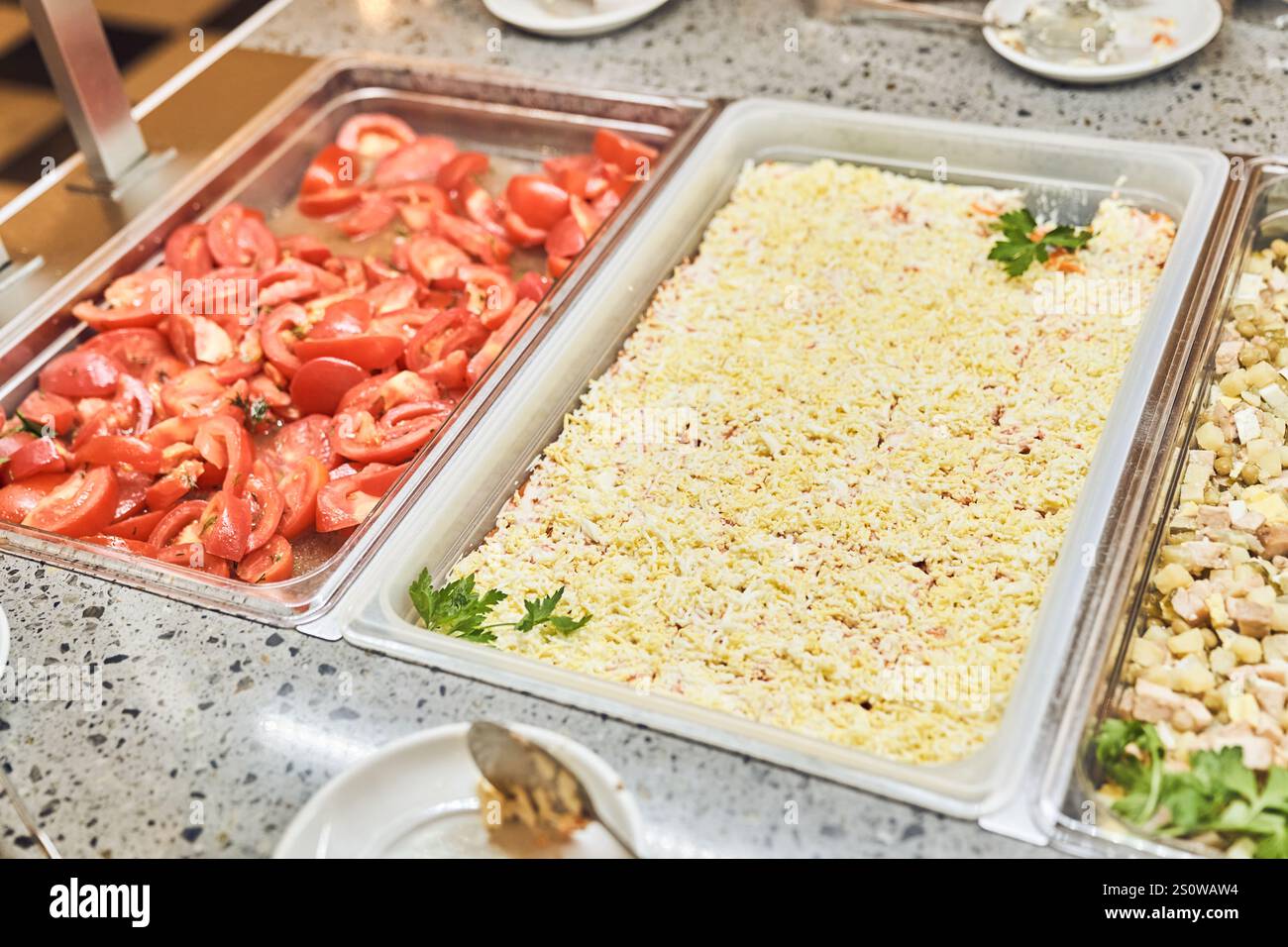Fresh sliced tomatoes and mimosa salad, traditional dishes in metal ...